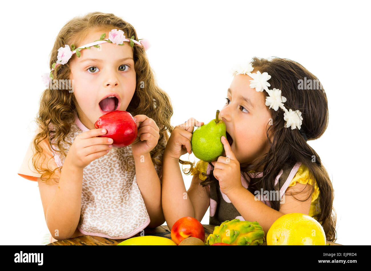 Beautiful healthy little girls eating delicious fresh fruits Stock ...