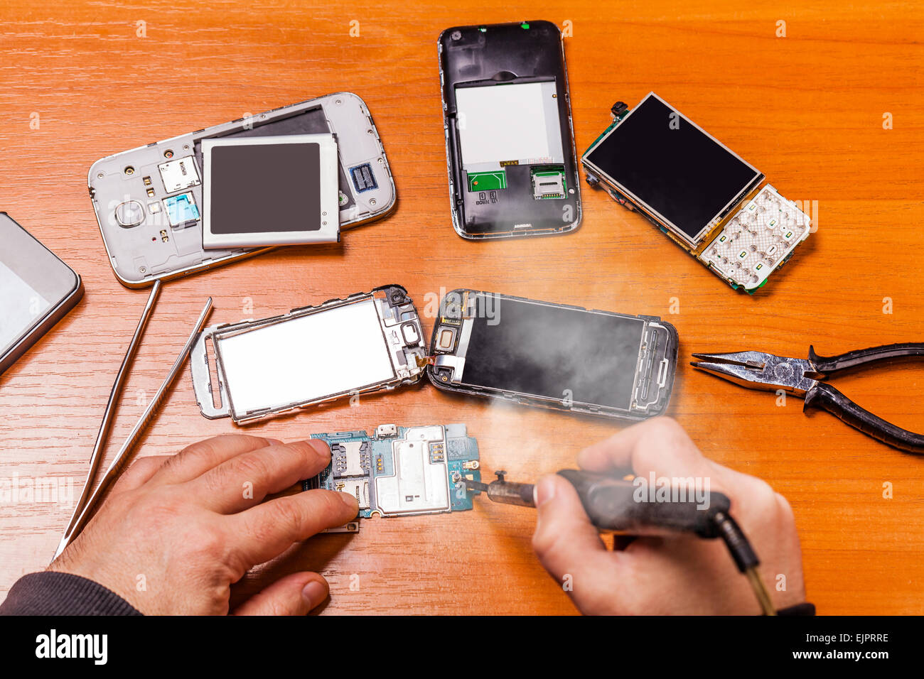 soldering, repair broken phone on a wooden background Stock Photo - Alamy