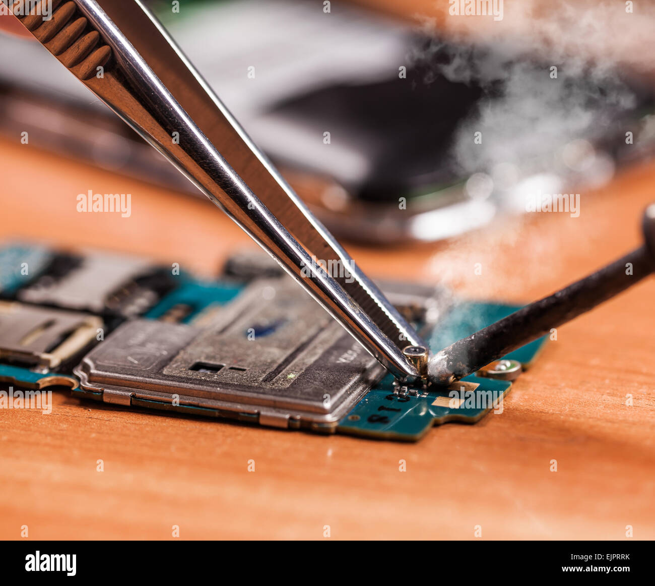 repair a broken mobile phone closeup on wooden background Stock Photo ...
