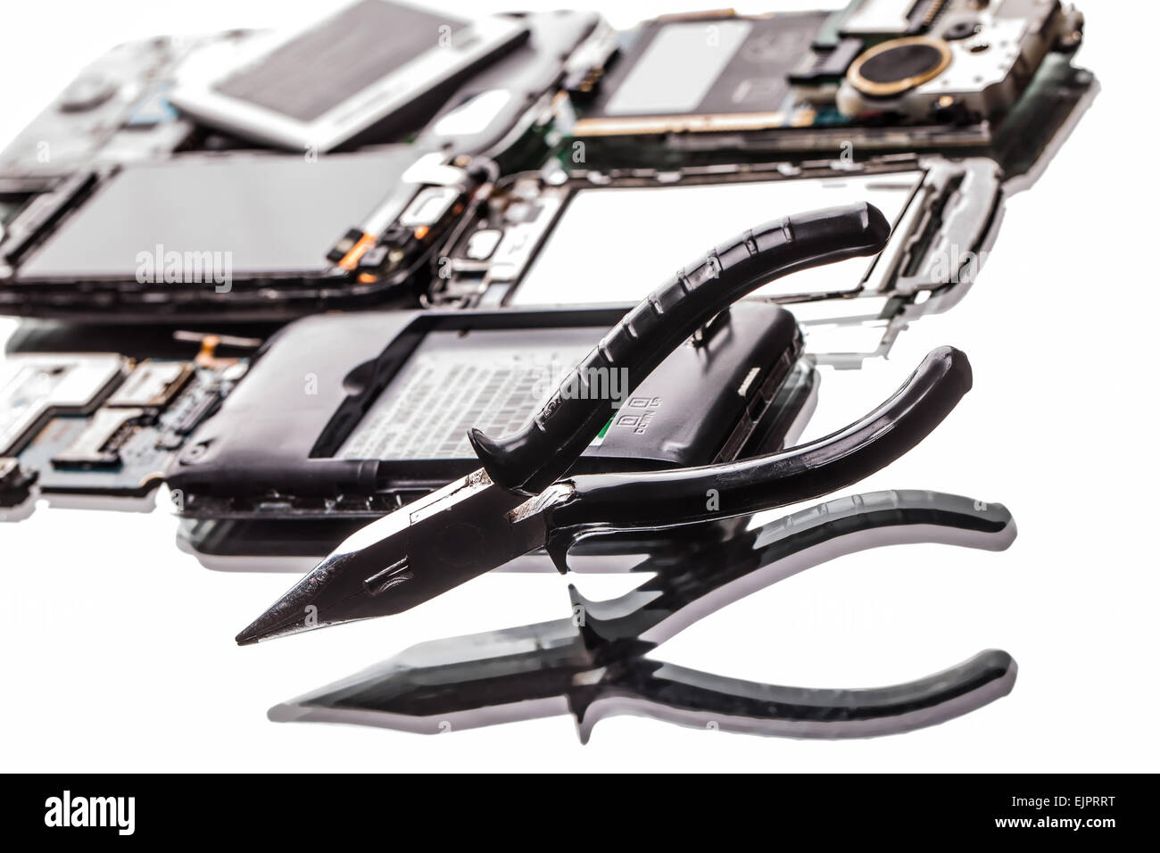 dismantle the phone and pliers on a light background Stock Photo - Alamy