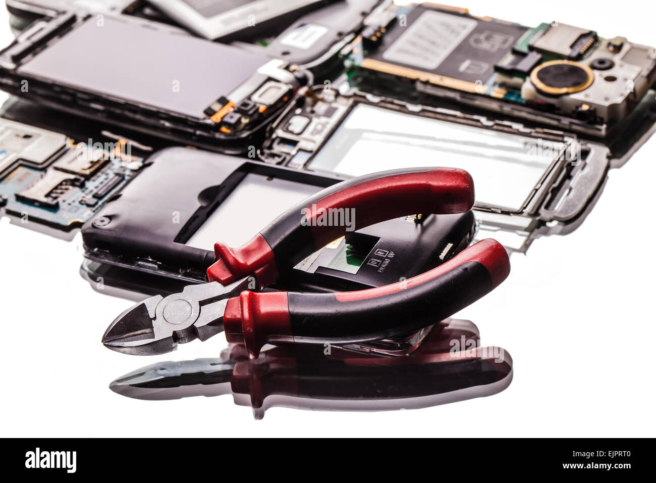 broken phones and clippers on a light background Stock Photo - Alamy