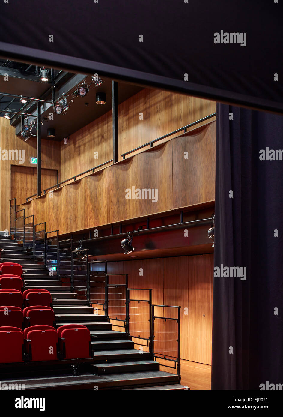 Detailed view of retractable bleachers and acoustic walnut baffle. Lady ...