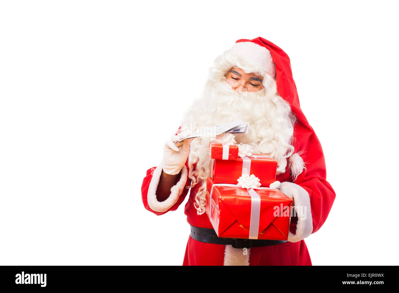 santa claus holding letters from kids and gifts on white background ...