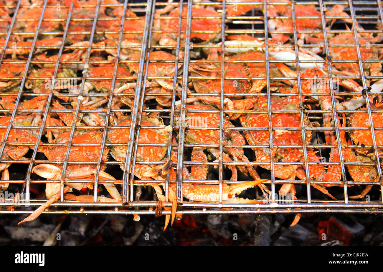Grilled crab on flaming grill. Charcoal fire grill. Barbecue embers ...