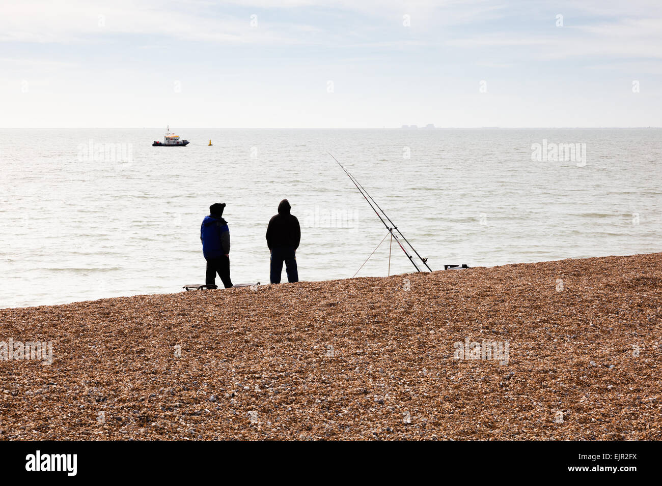 Two anglers on the beach at Hythe, Kent, UK Stock Photo - Alamy
