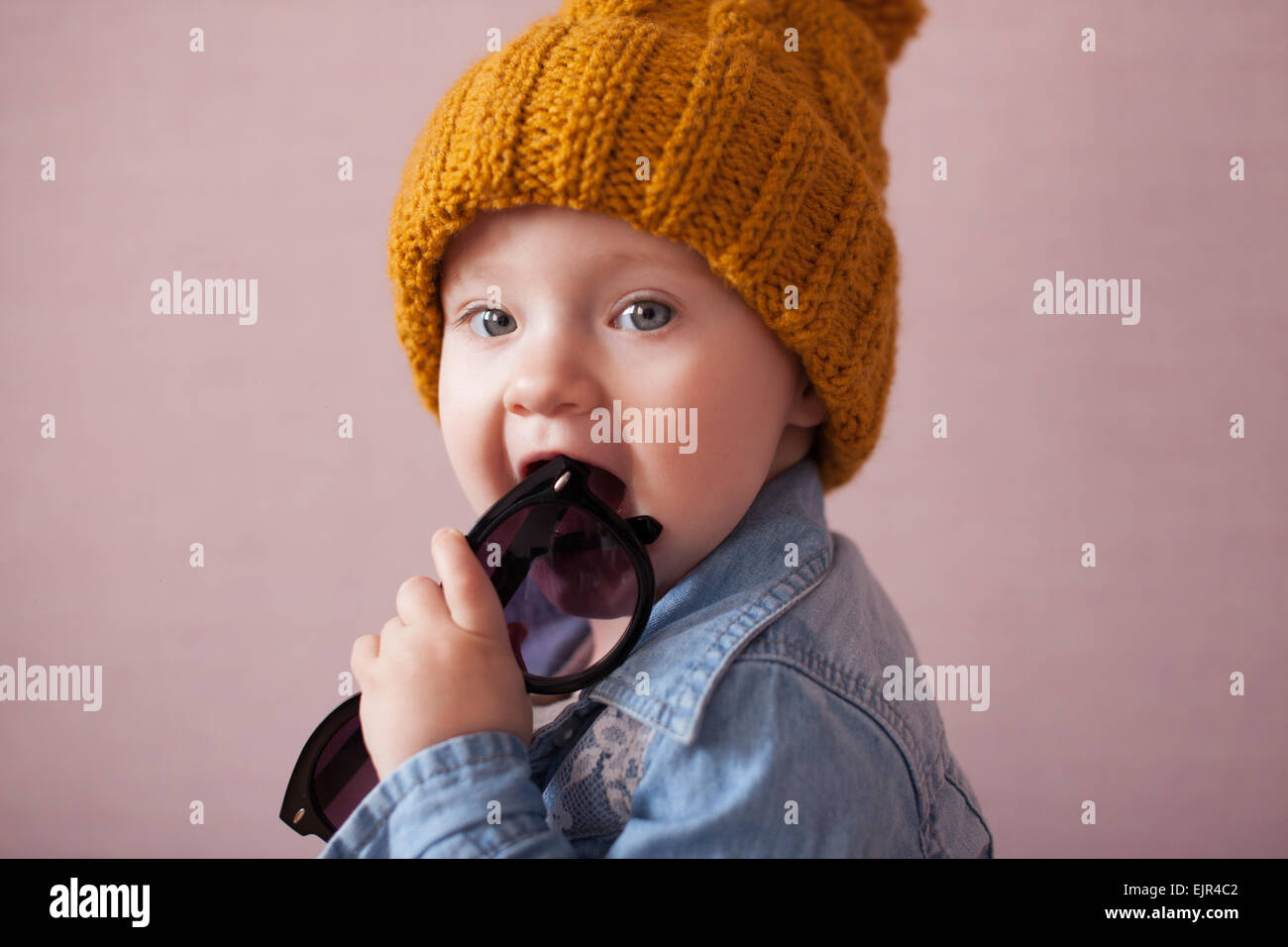 cute kid in knitted mustard color hat Stock Photo - Alamy