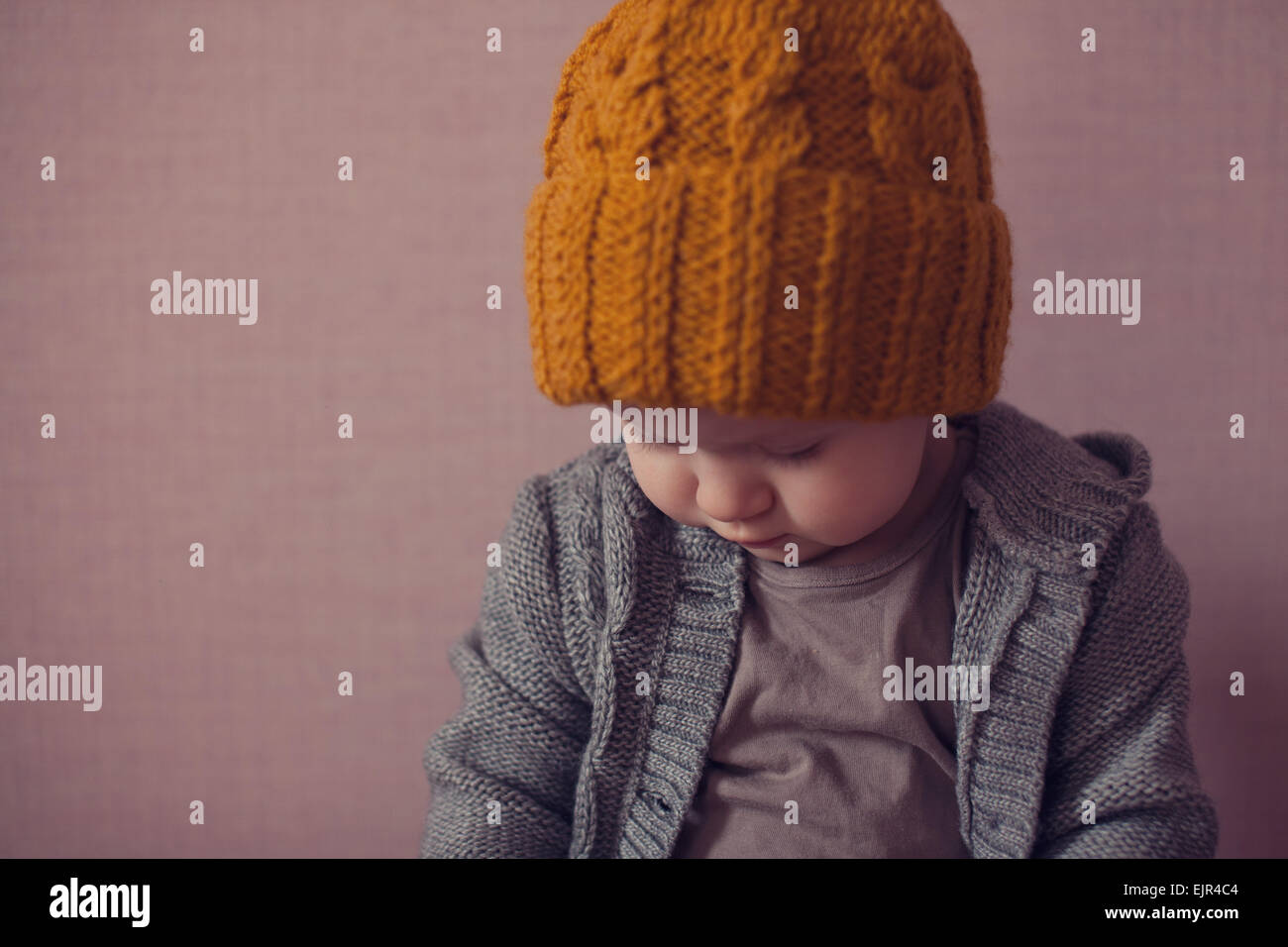 cute kid in knitted mustard color hat Stock Photo - Alamy