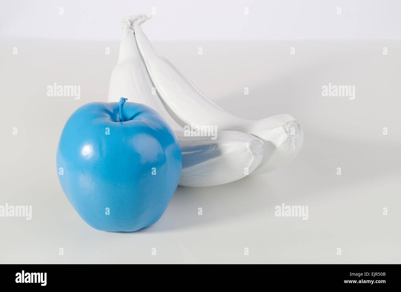 Blue apple and two white bananas Stock Photo - Alamy