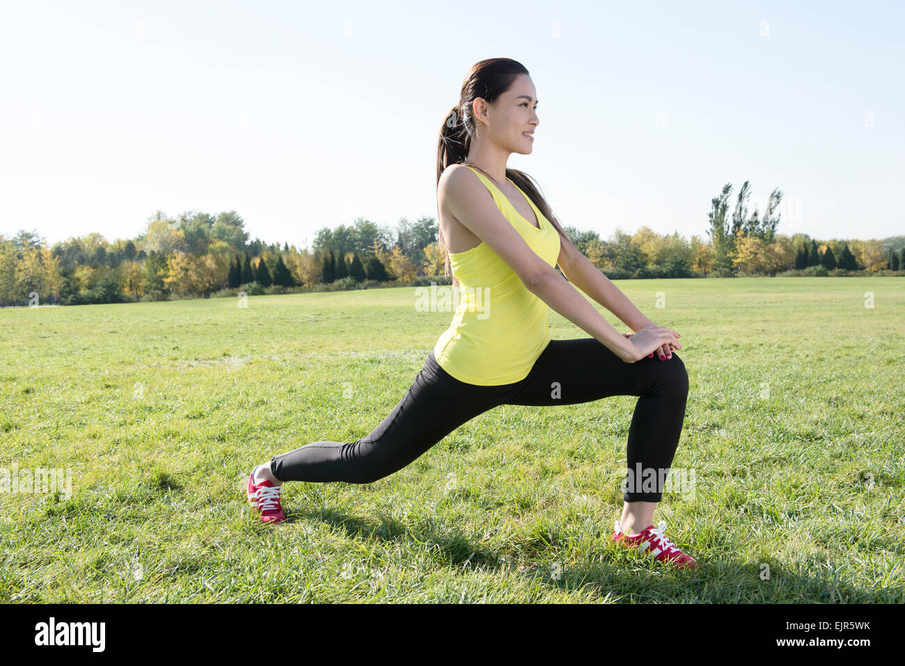 Young woman stretching Stock Photo - Alamy