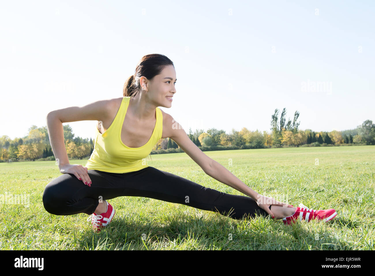 Young woman stretching Stock Photo - Alamy