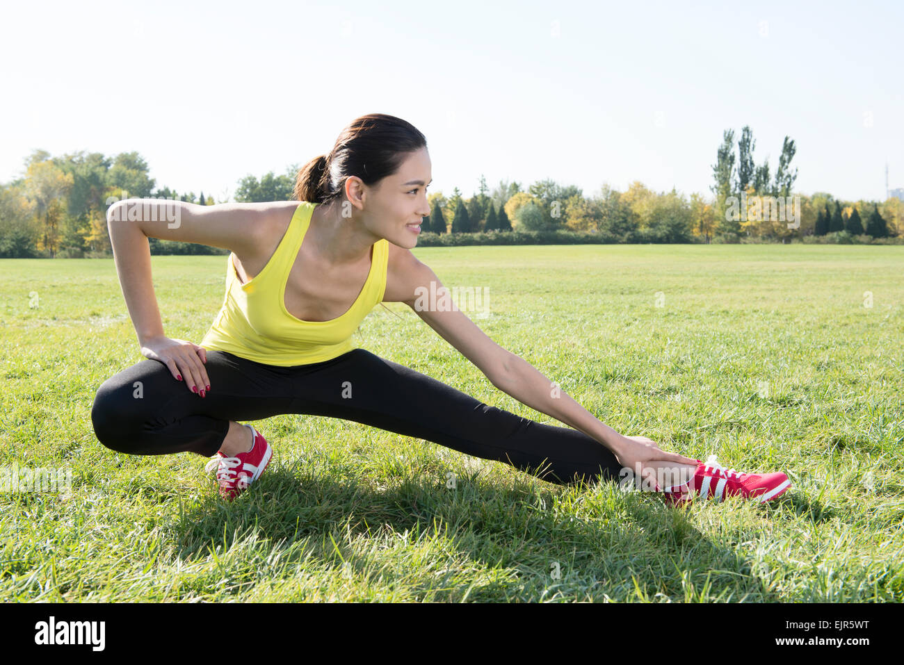 Young woman stretching Stock Photo - Alamy