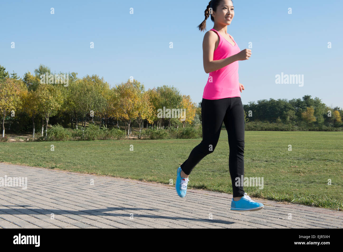 Asian woman jogging park hi-res stock photography and images - Alamy