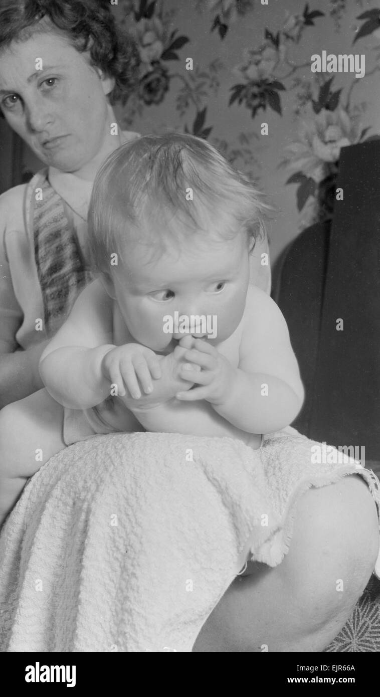 Archival baby on lap hi-res stock photography and images - Alamy