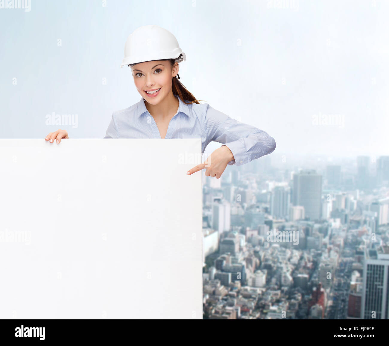 businesswoman in helmet pointing finger to board Stock Photo - Alamy