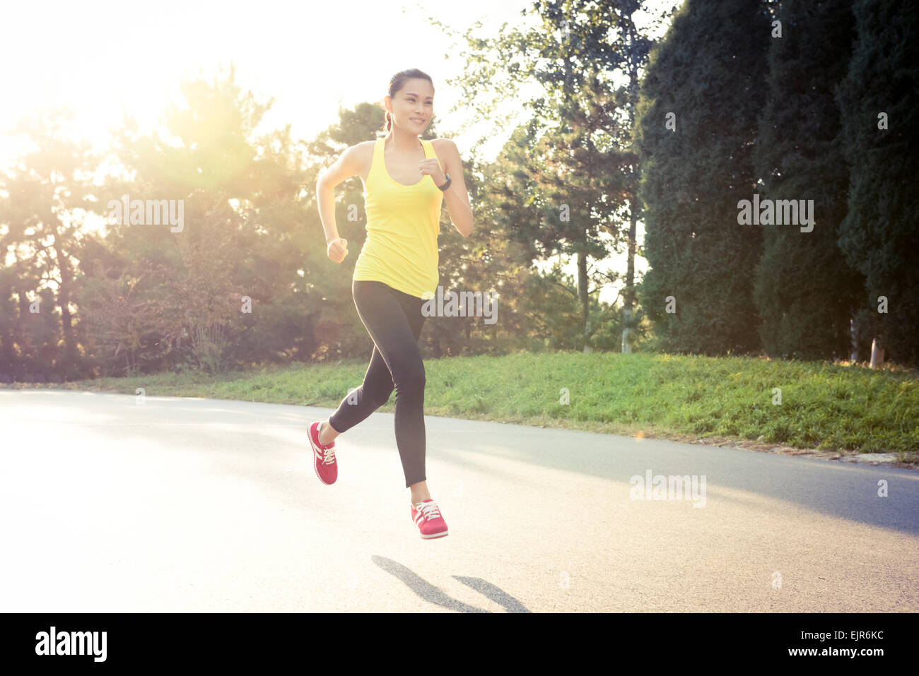 Young woman jogging Stock Photo - Alamy