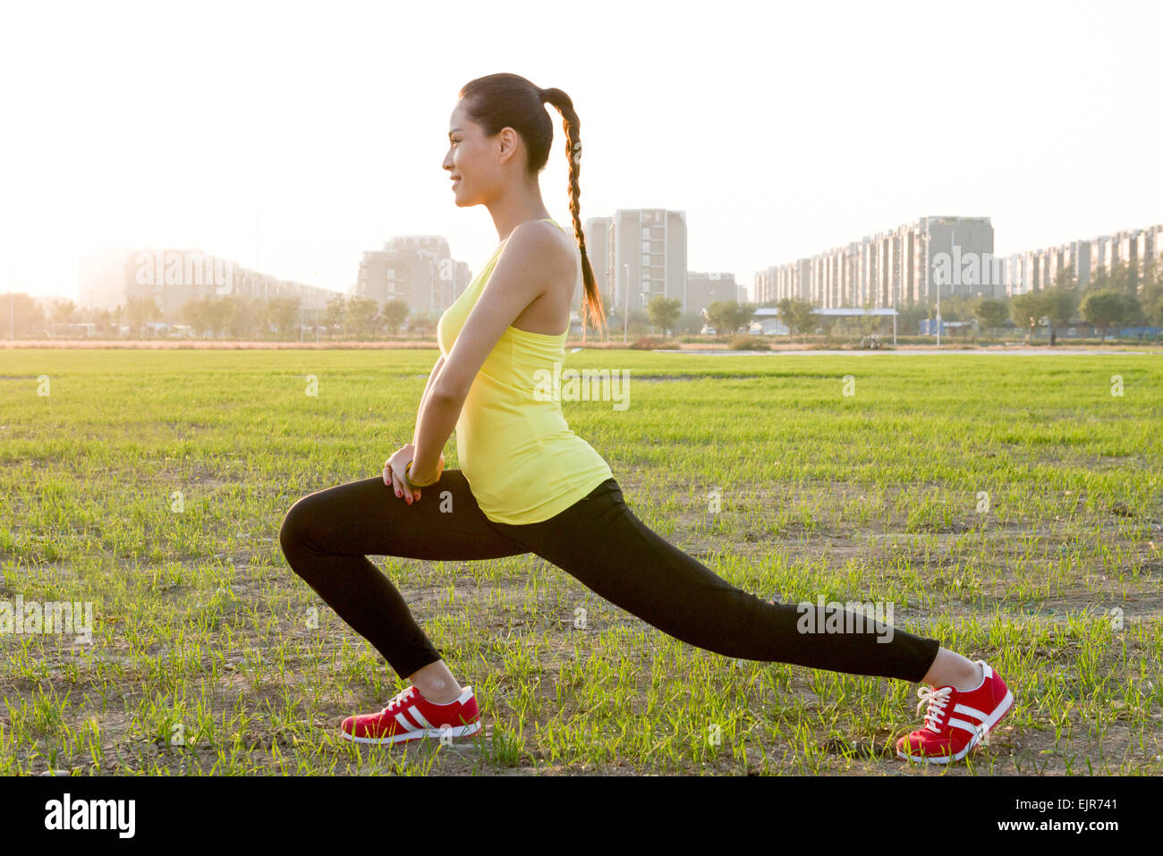 Young woman stretching Stock Photo - Alamy