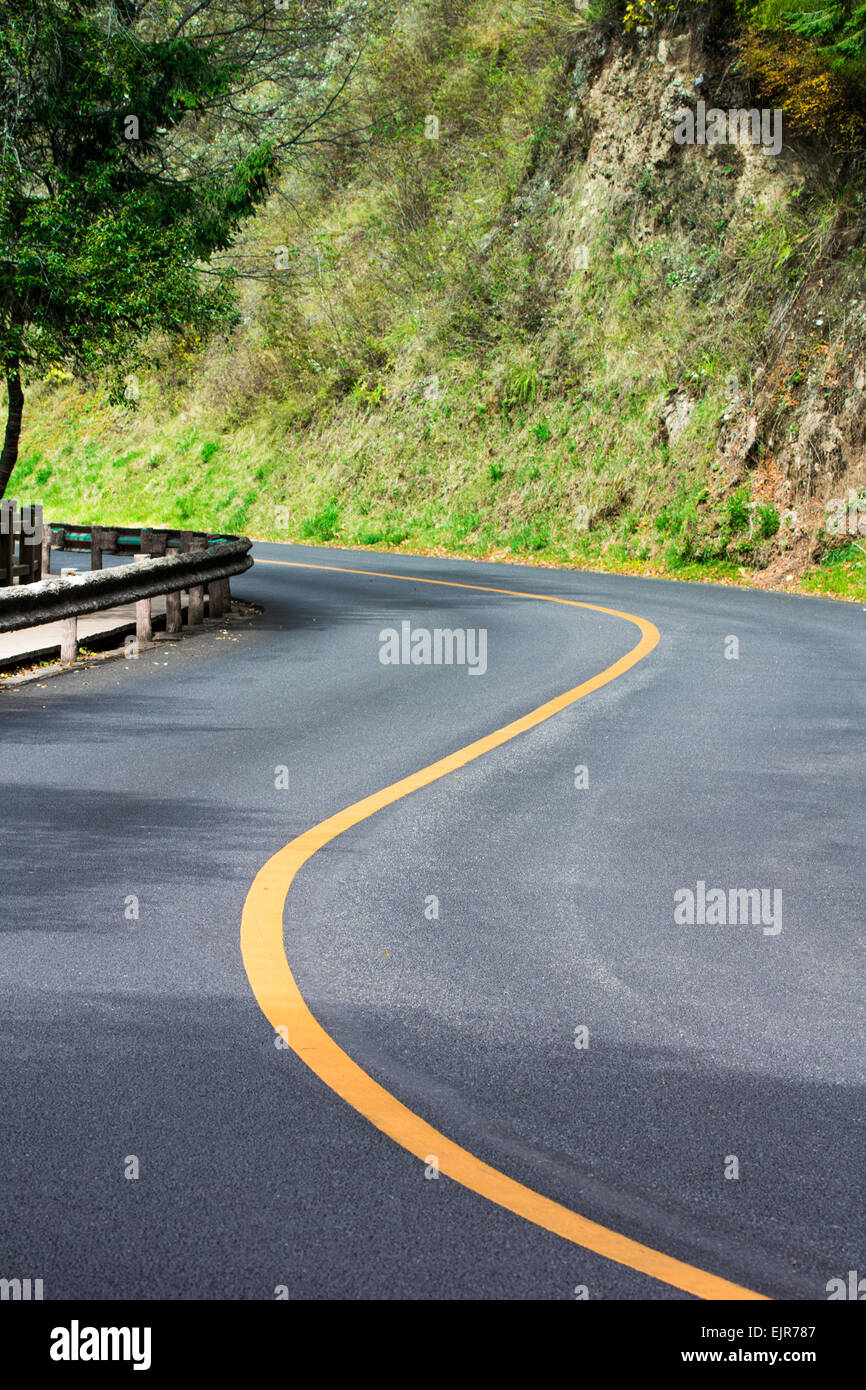 Empty road curve with tree on both side Stock Photo - Alamy