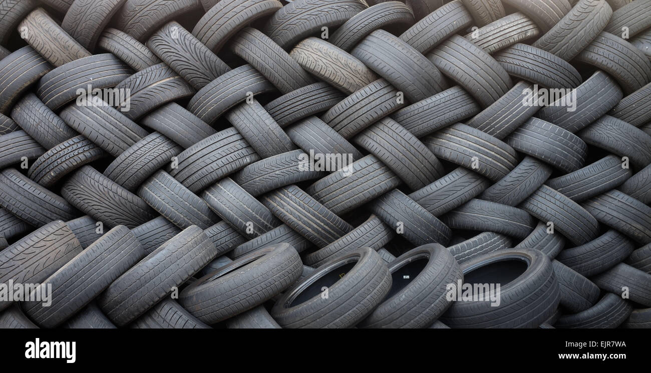 A stack of car tyres at a garage forms a pattern and fills the screen ...
