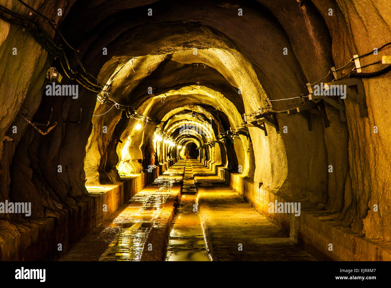 cave tunnel mine long walk way with light Stock Photo - Alamy