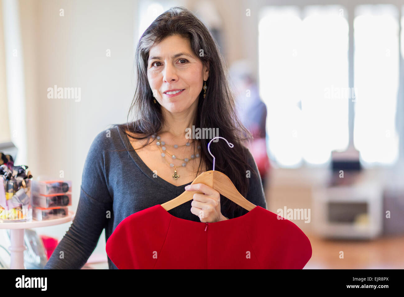 Hispanic small business owner working in store Stock Photo - Alamy