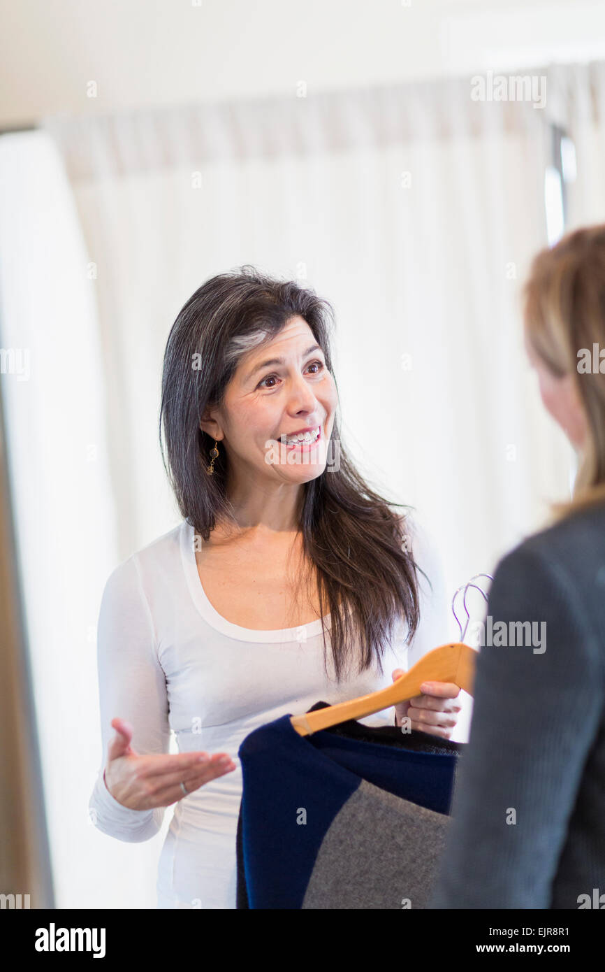 Small business owner talking to customer in store Stock Photo - Alamy