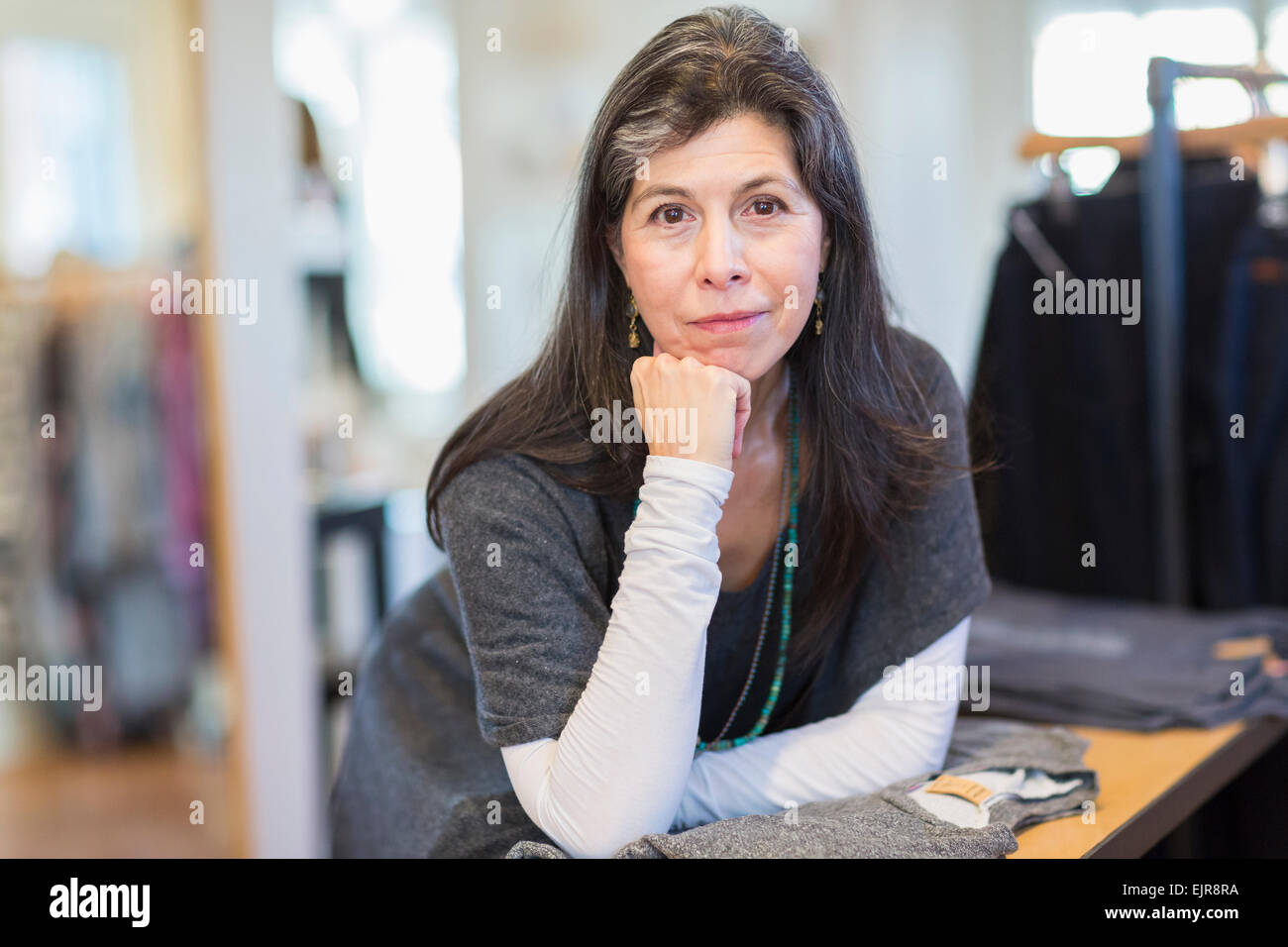 Hispanic small business owner smiling in store Stock Photo - Alamy