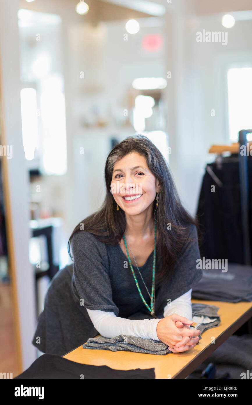 Hispanic small business owner smiling in store Stock Photo - Alamy