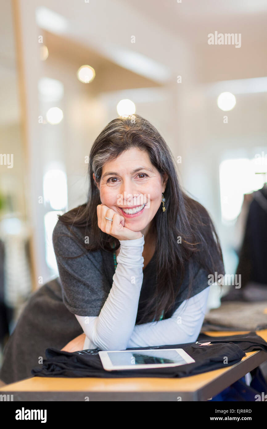 Hispanic small business owner using digital tablet in store Stock Photo ...