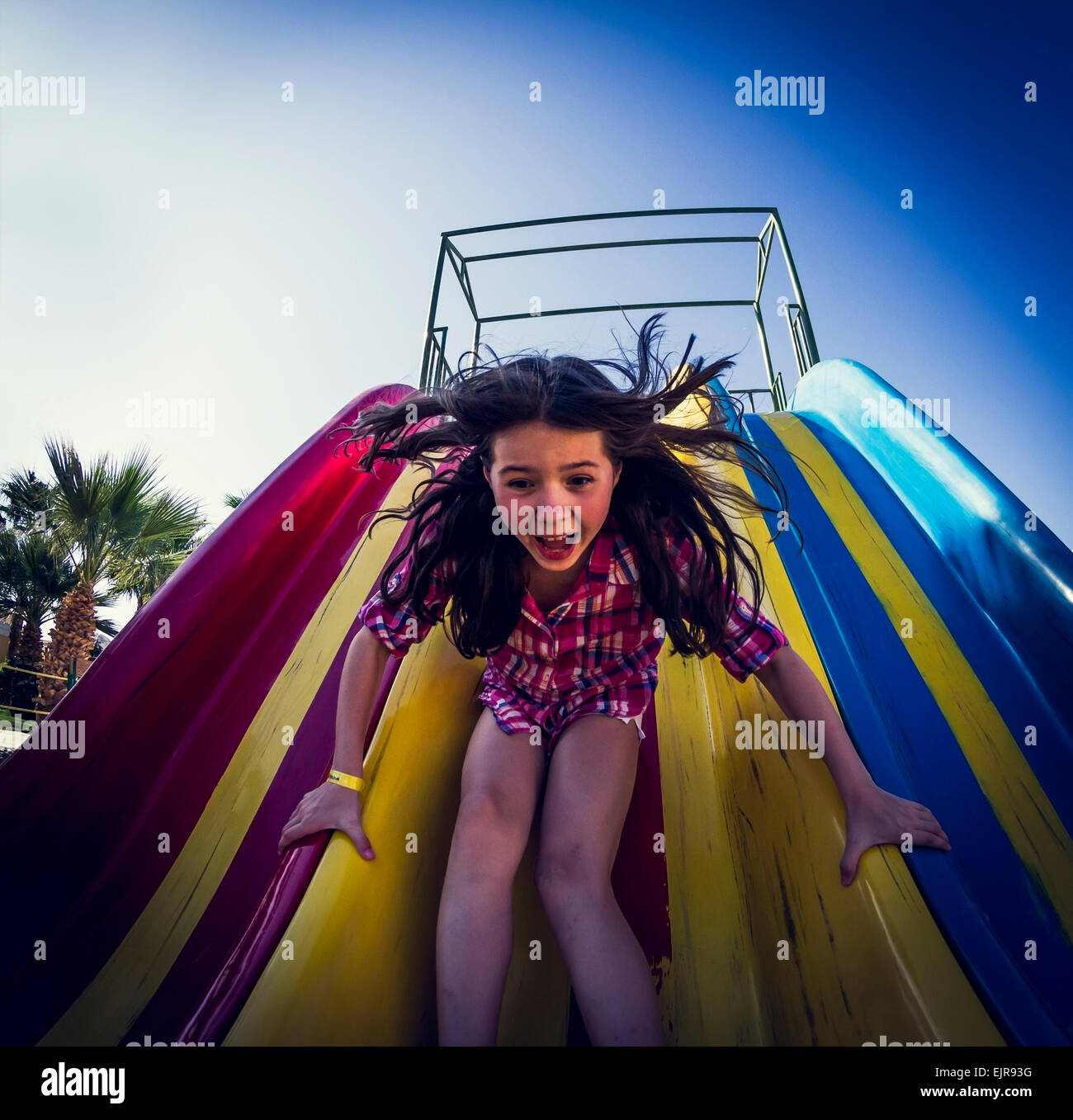 Caucasian girl playing on slide Stock Photo - Alamy