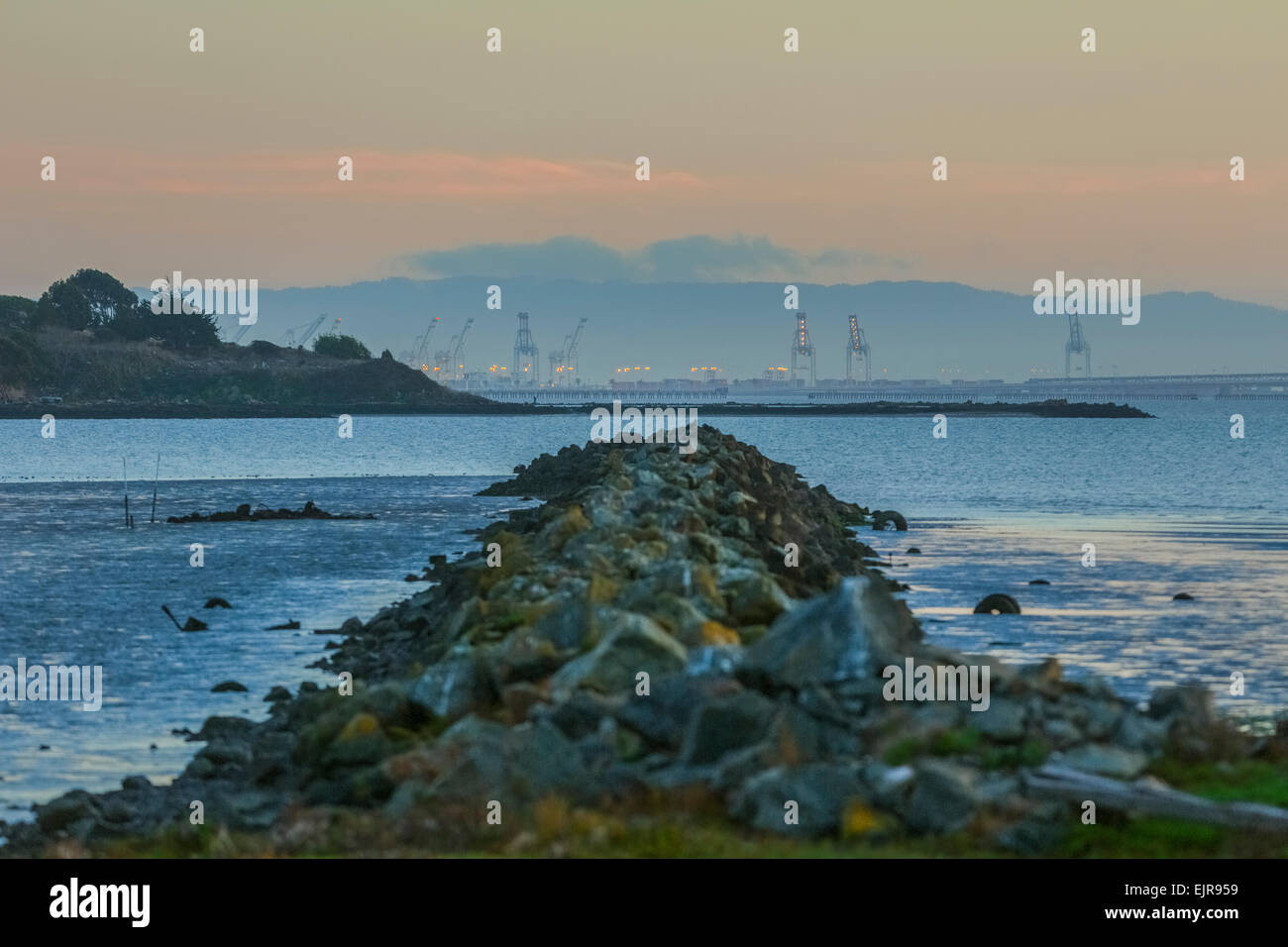 Rocky jetty in ocean bay Stock Photo - Alamy