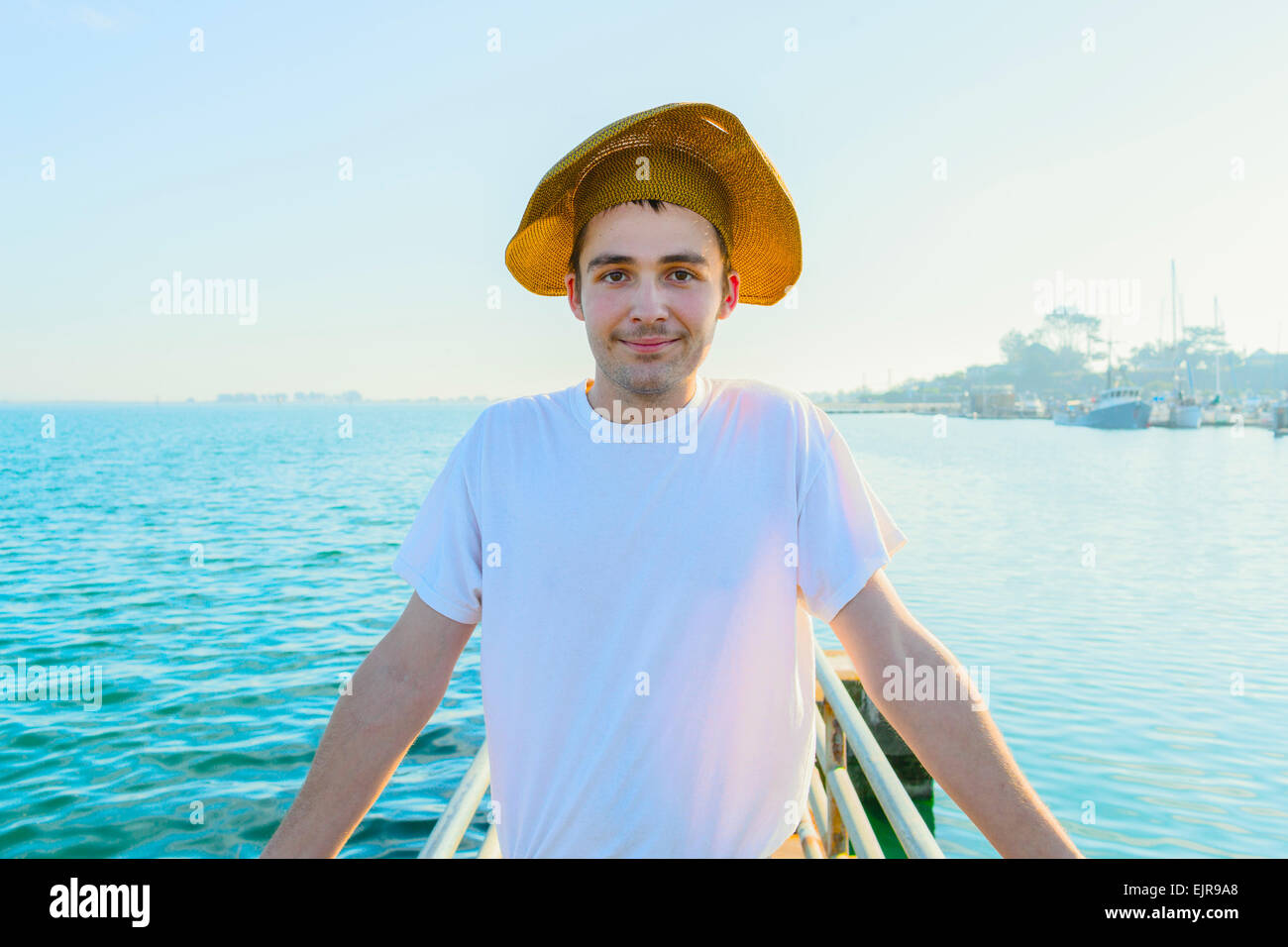 Caucasian man wearing sun hat on pier Stock Photo - Alamy