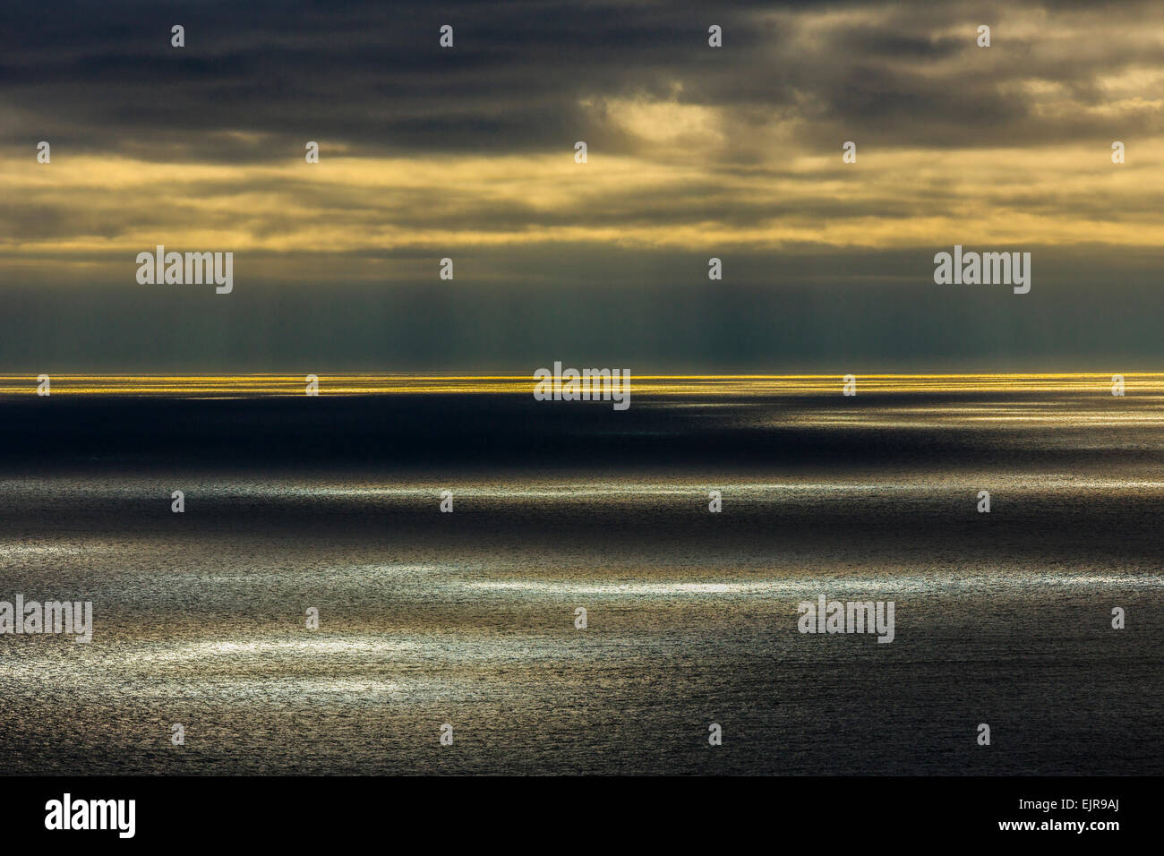Sunbeams shining over ocean seascape Stock Photo - Alamy