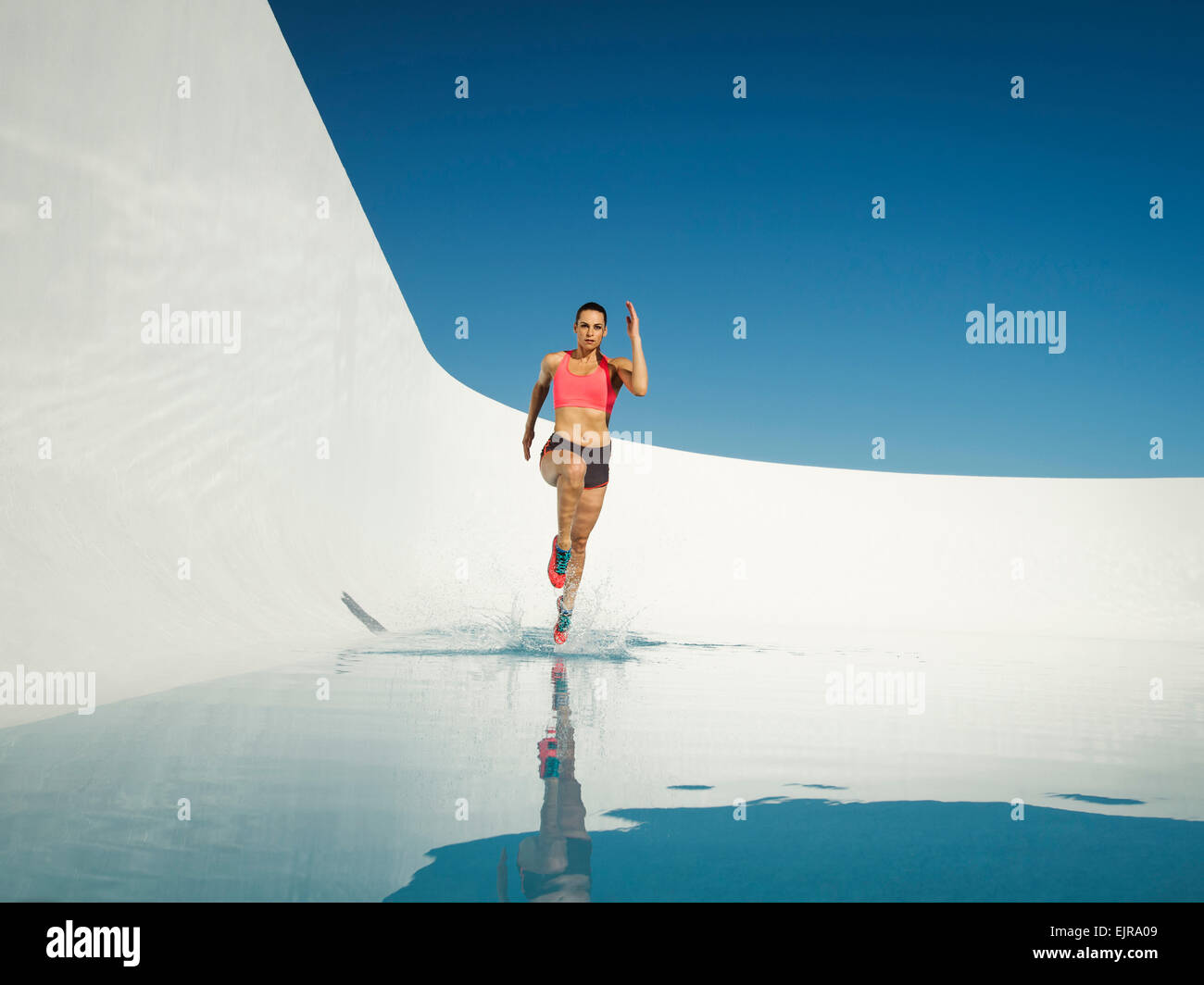 Caucasian woman running on water surface Stock Photo - Alamy