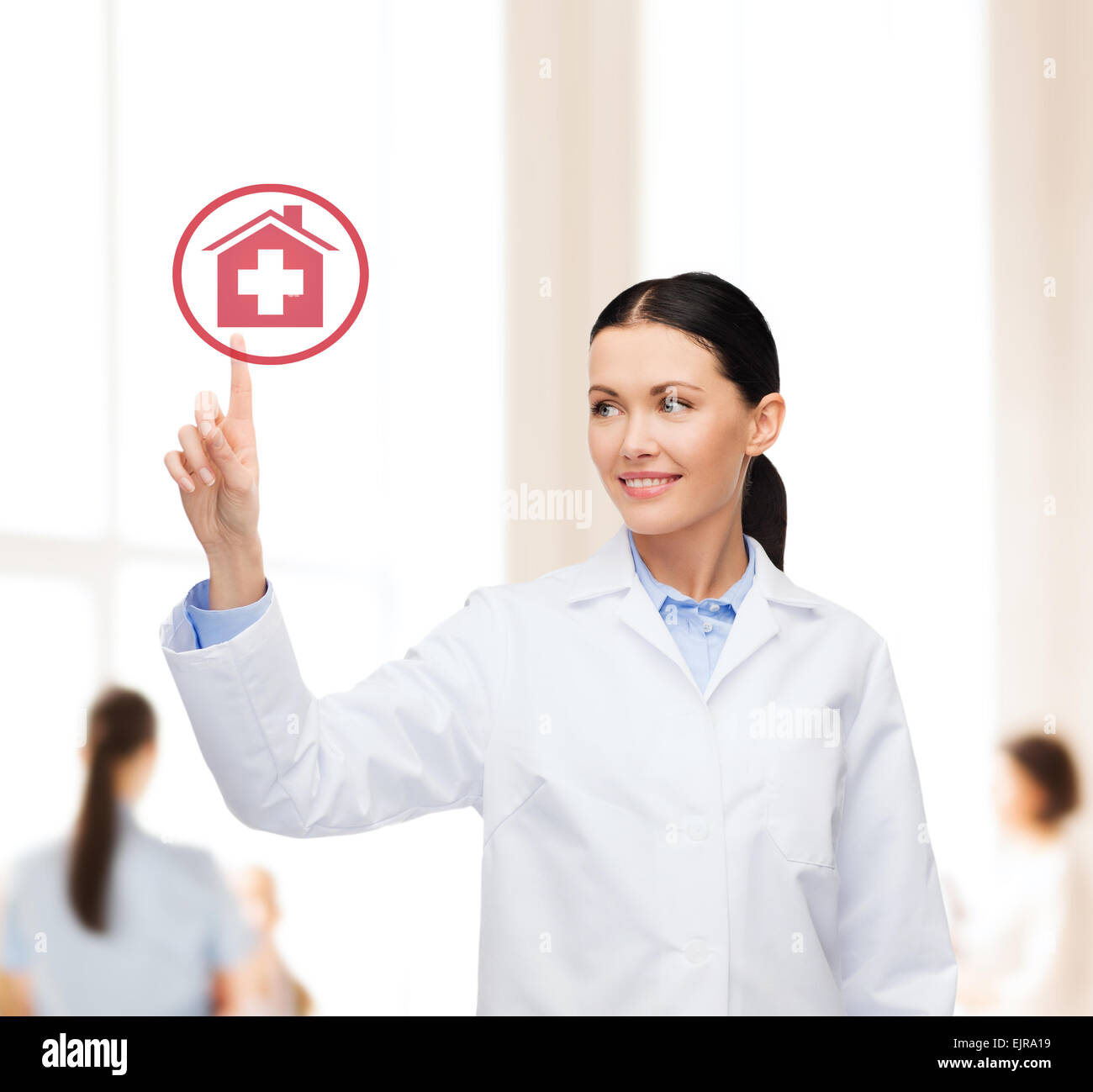 smiling female doctor pointing to hospital sign Stock Photo - Alamy
