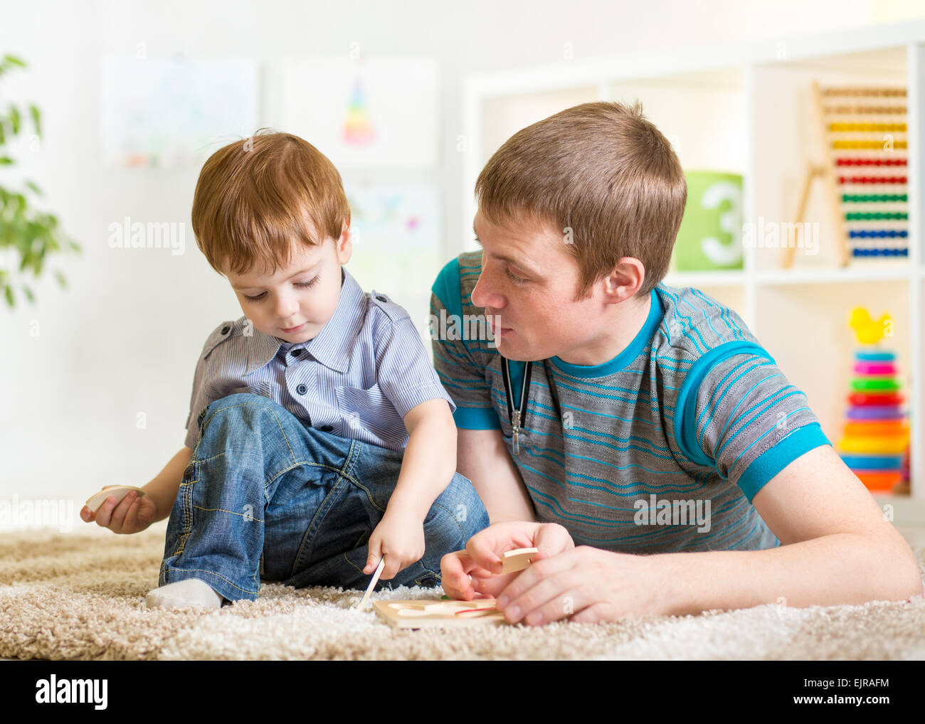 Kid boy and father play with toys Stock Photo - Alamy