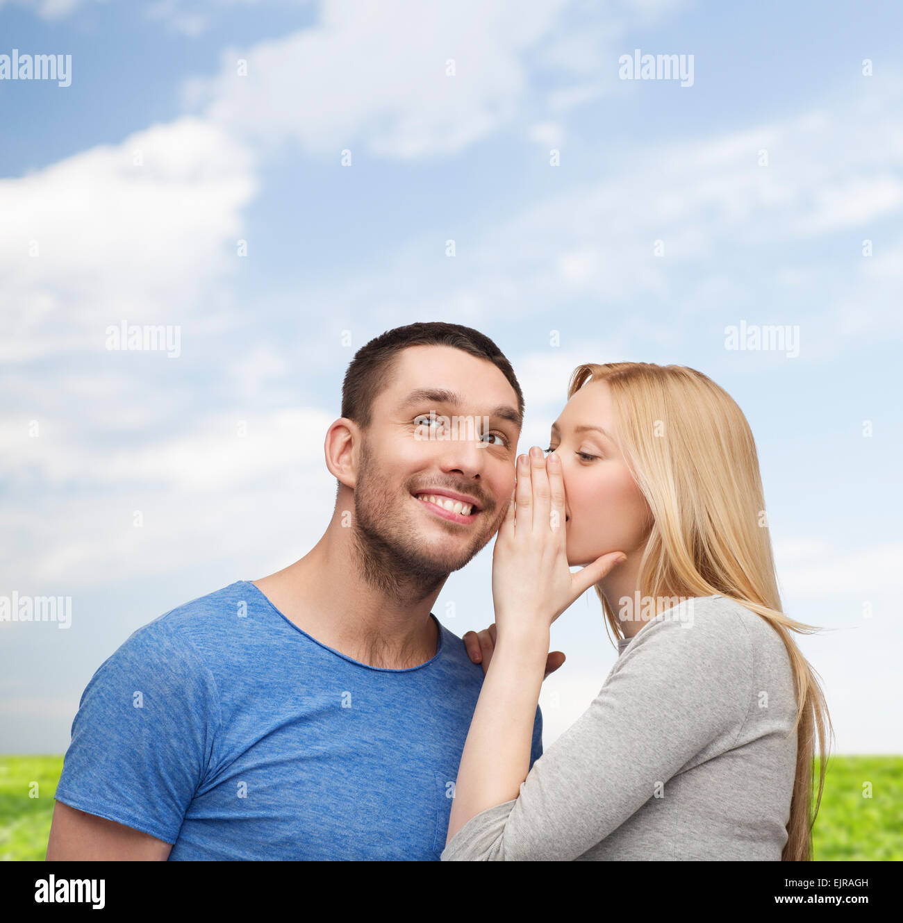 smiling girlfriend telling boyfriend secret Stock Photo - Alamy