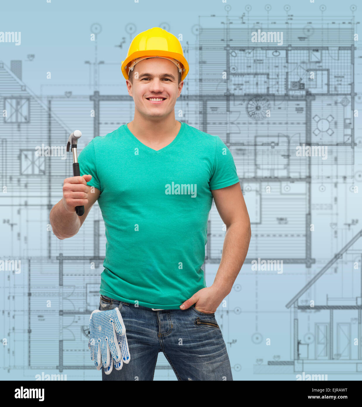 smiling manual worker in helmet with hammer Stock Photo - Alamy