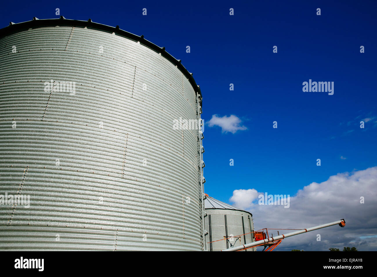 Low angle view of silos under blue sky Stock Photo - Alamy