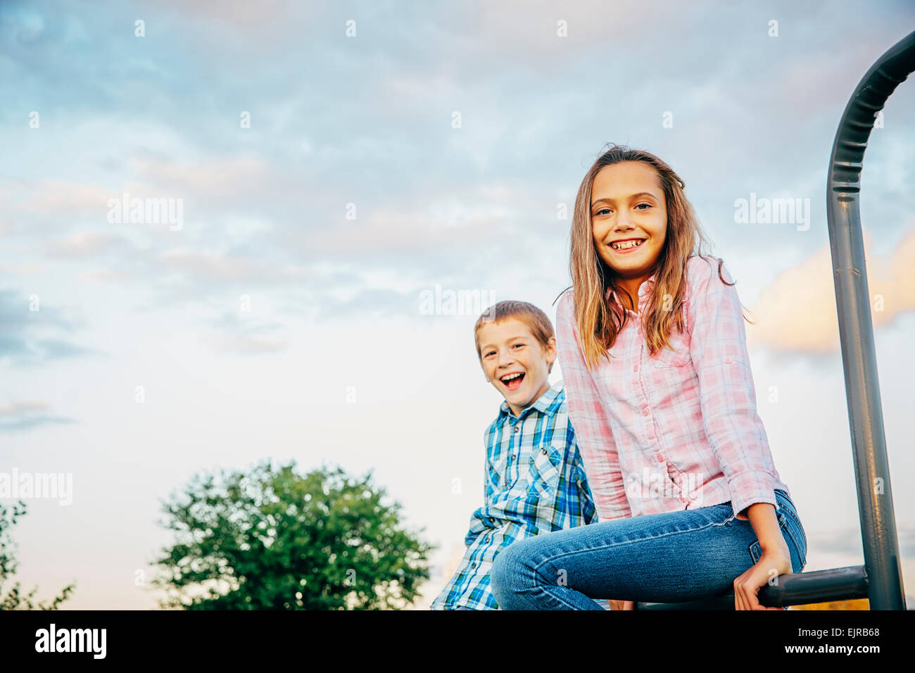 Low angle view of Caucasian children sitting outdoors Stock Photo - Alamy