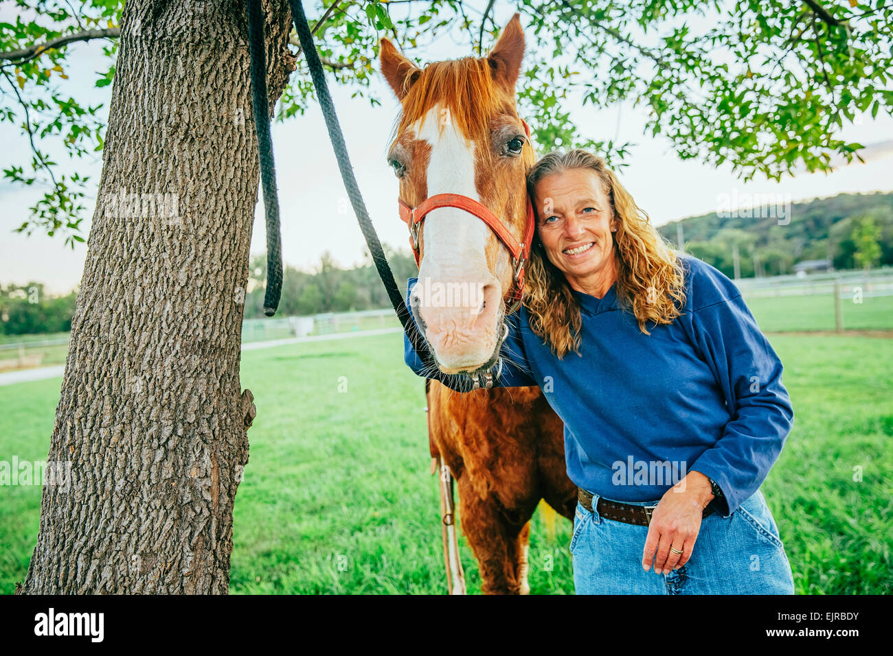Caucasian woman hugging horse on farm Stock Photo - Alamy