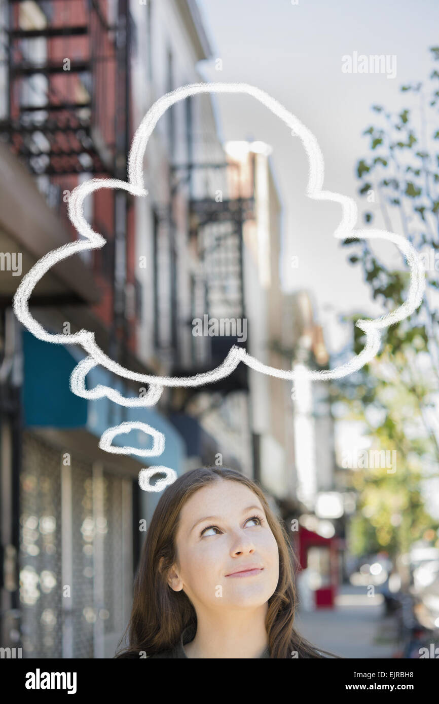 Caucasian woman looking up at thought bubble Stock Photo - Alamy