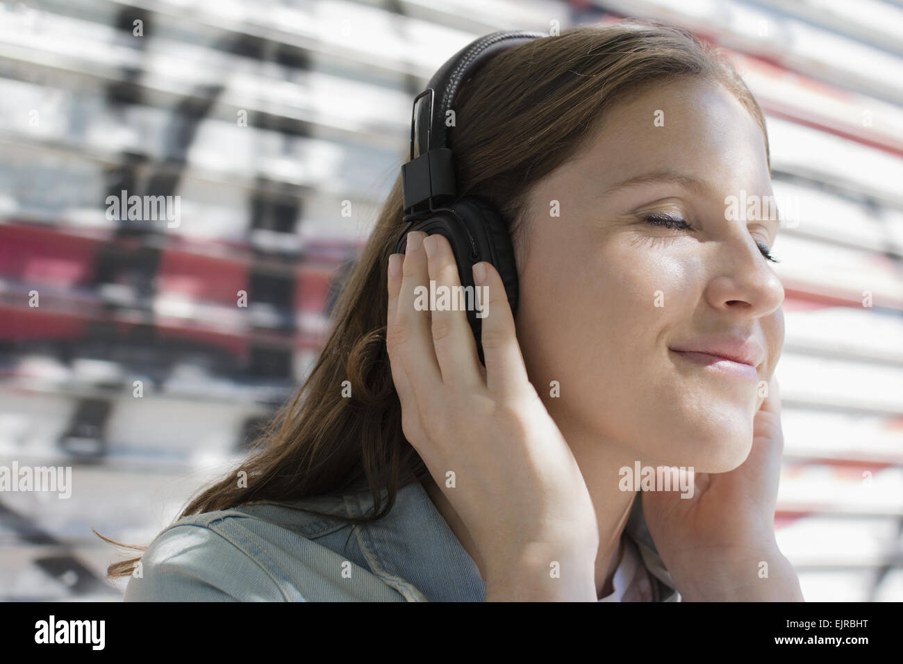 Close up of Caucasian woman listening to headphones Stock Photo - Alamy