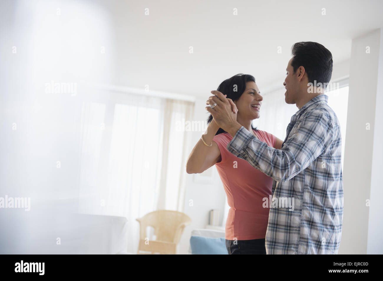 Couple dancing in living room Stock Photo - Alamy