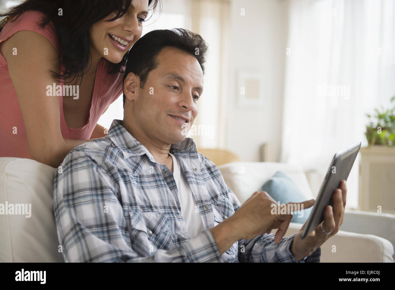 Woman in 40s tablet sofa hi-res stock photography and images - Alamy