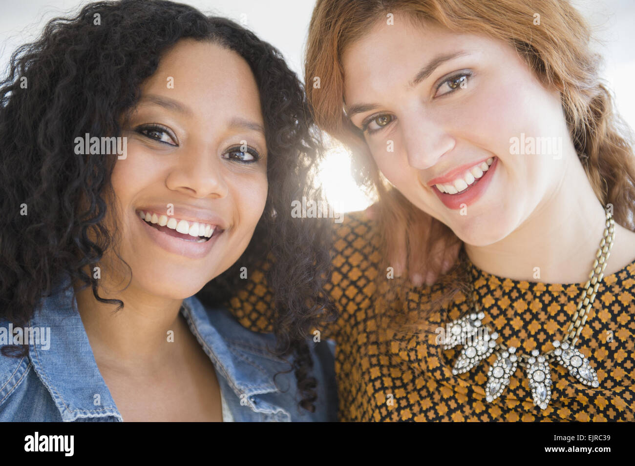 Close up of smiling women hugging Stock Photo - Alamy