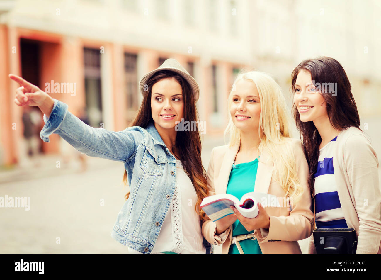 beautiful girls looking for direction in the city Stock Photo - Alamy