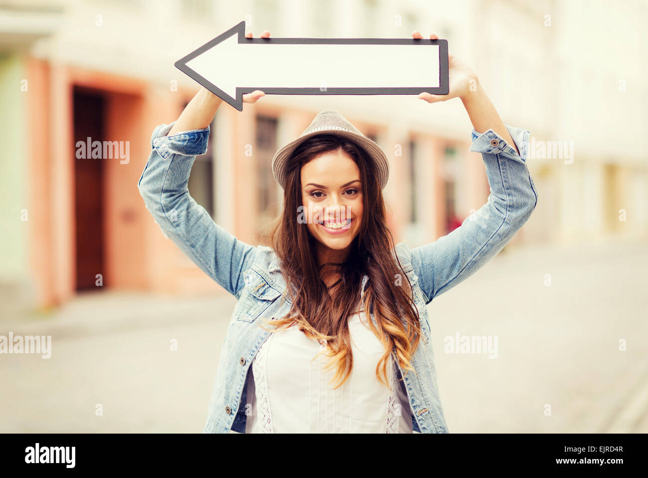 girl showing direction with arrow in the city Stock Photo - Alamy
