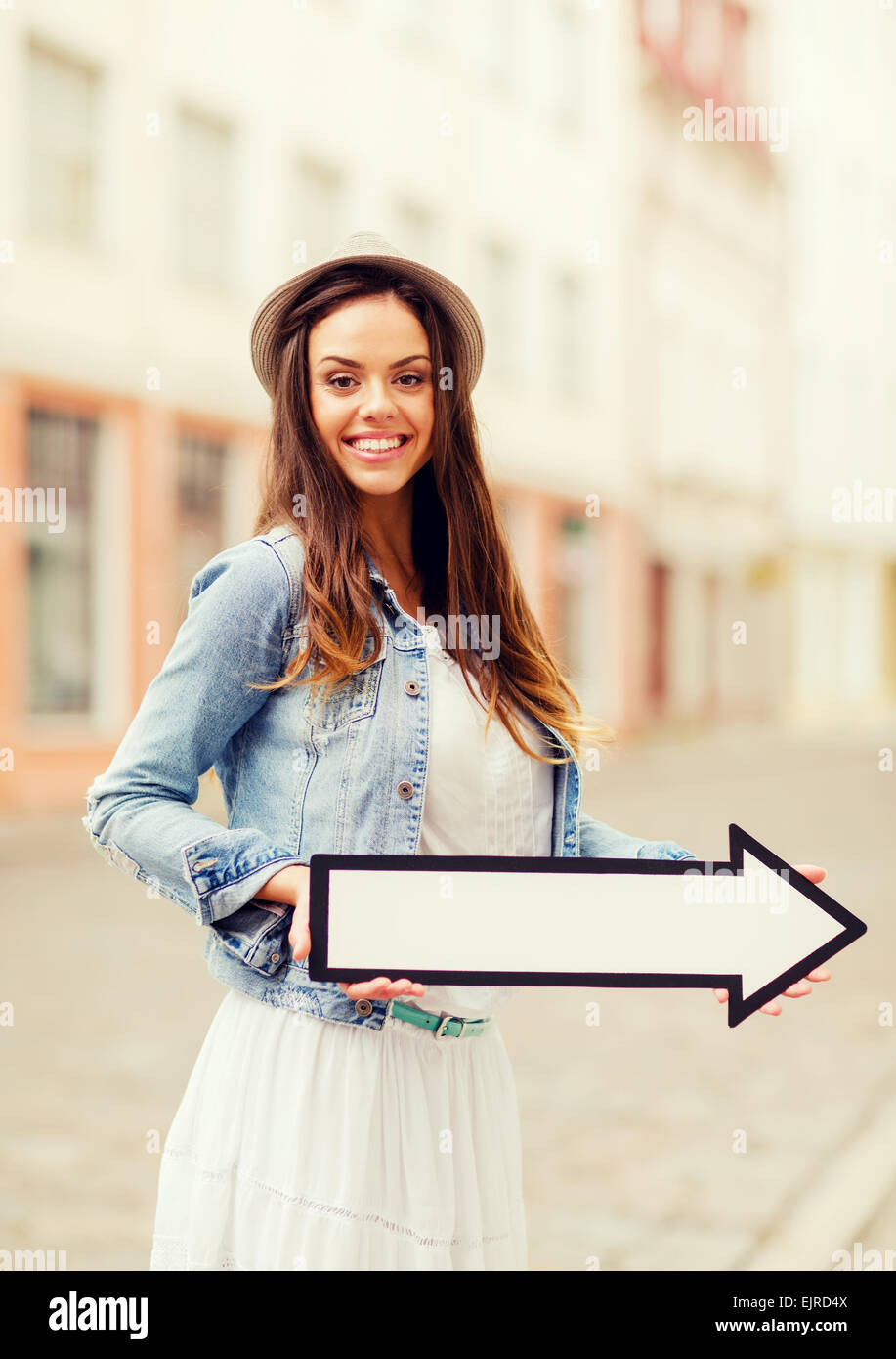 girl showing direction with arrow in the city Stock Photo - Alamy