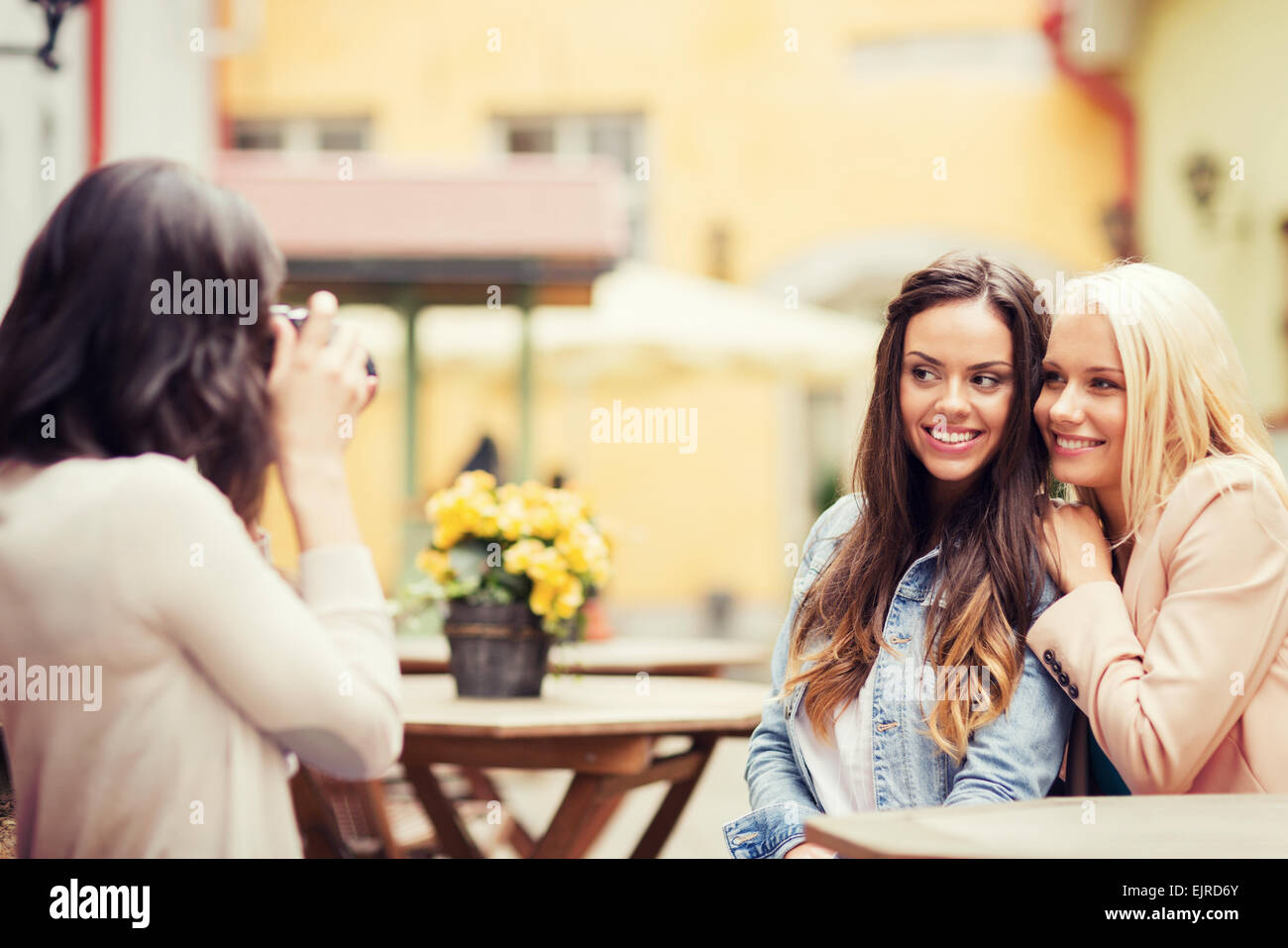 beautiful girls taking picture in cafe in city Stock Photo - Alamy