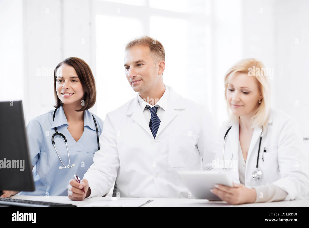 doctors looking at computer on meeting Stock Photo - Alamy